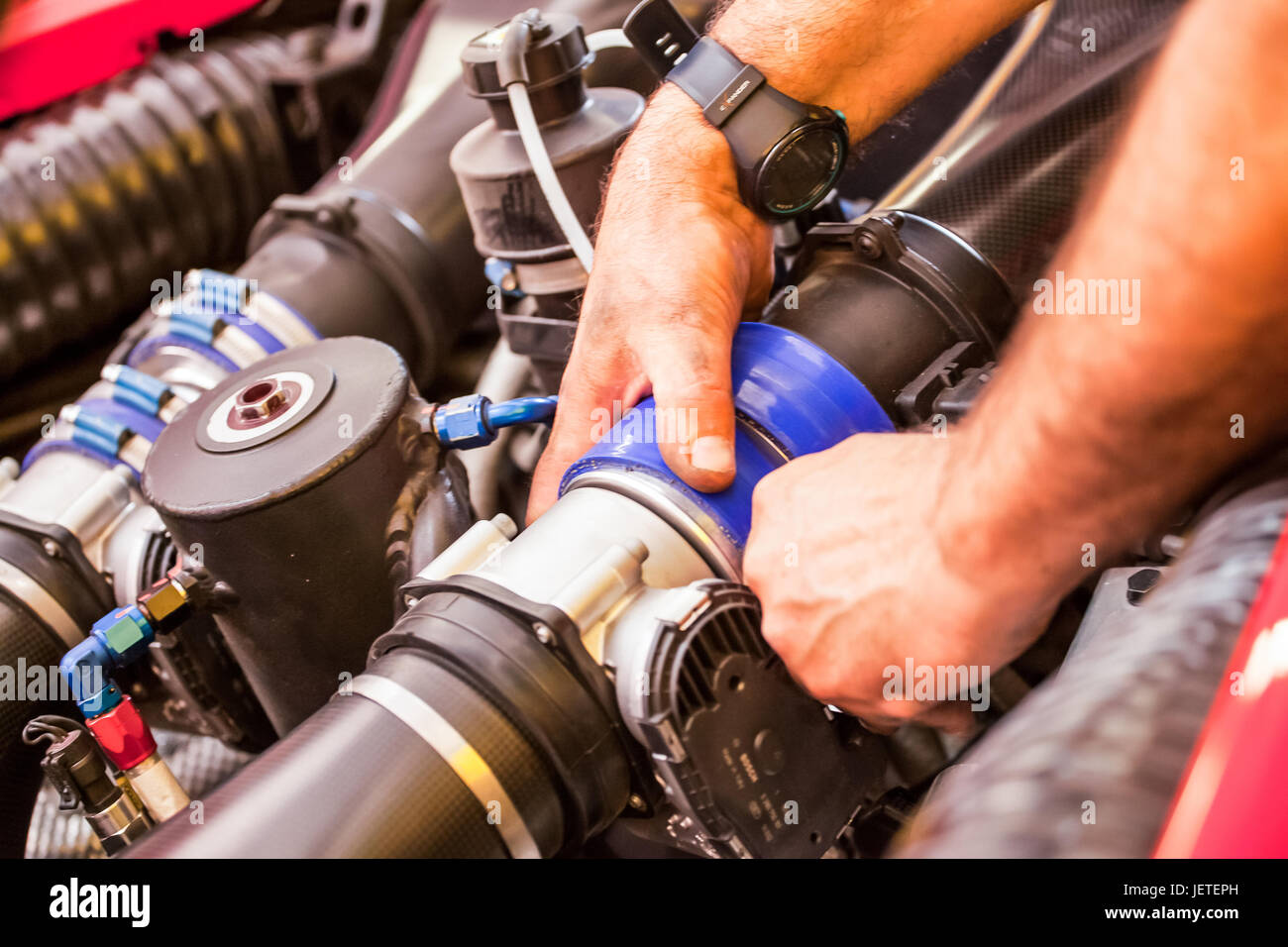 Workman checking engine Stock Photo - Alamy