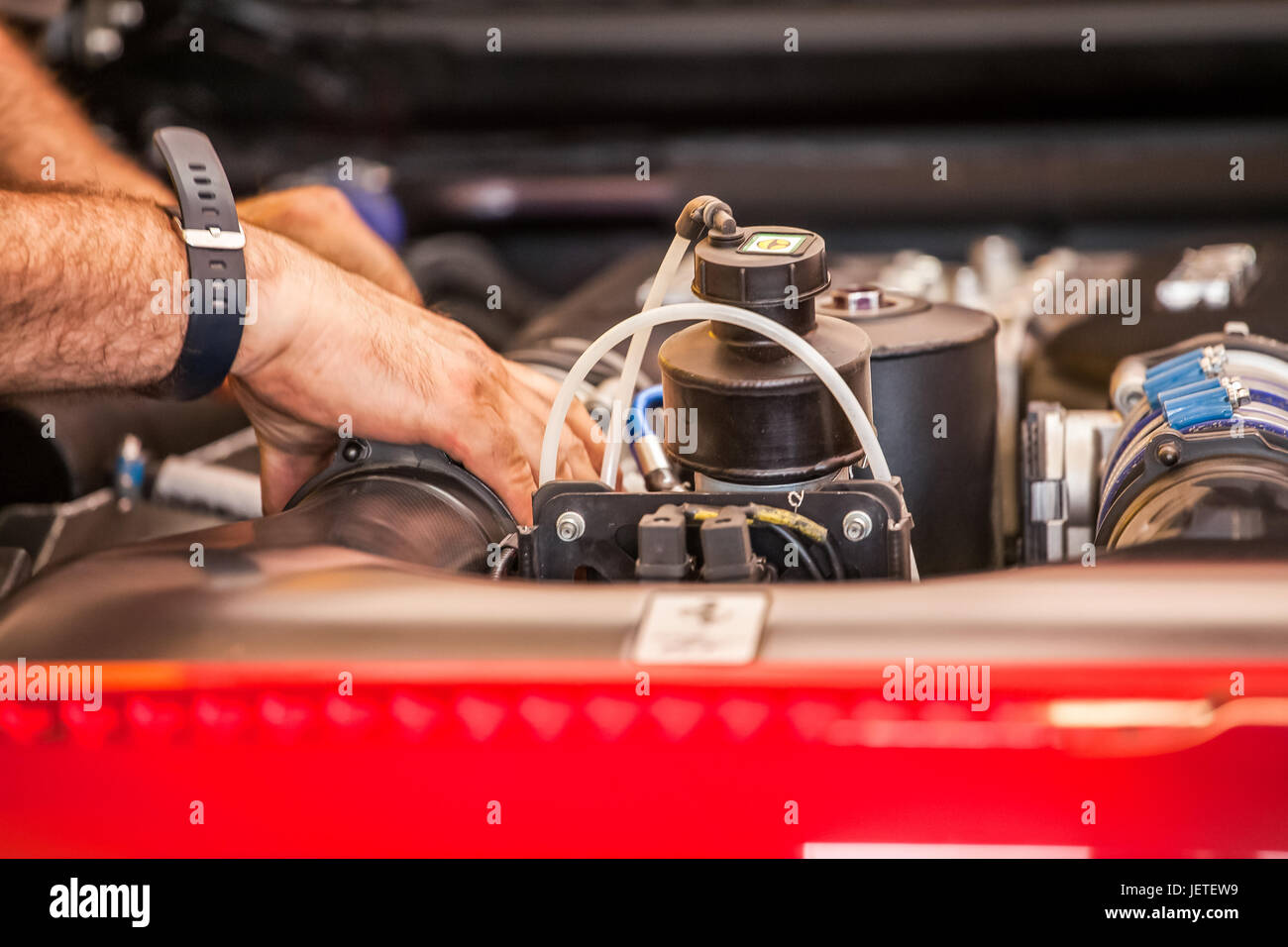Workman checking engine Stock Photo - Alamy