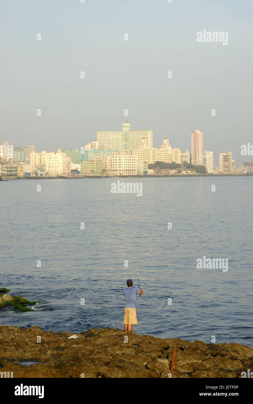 Cuba, Havana, town view, bile coast, angler, back view, the Caribbean ...
