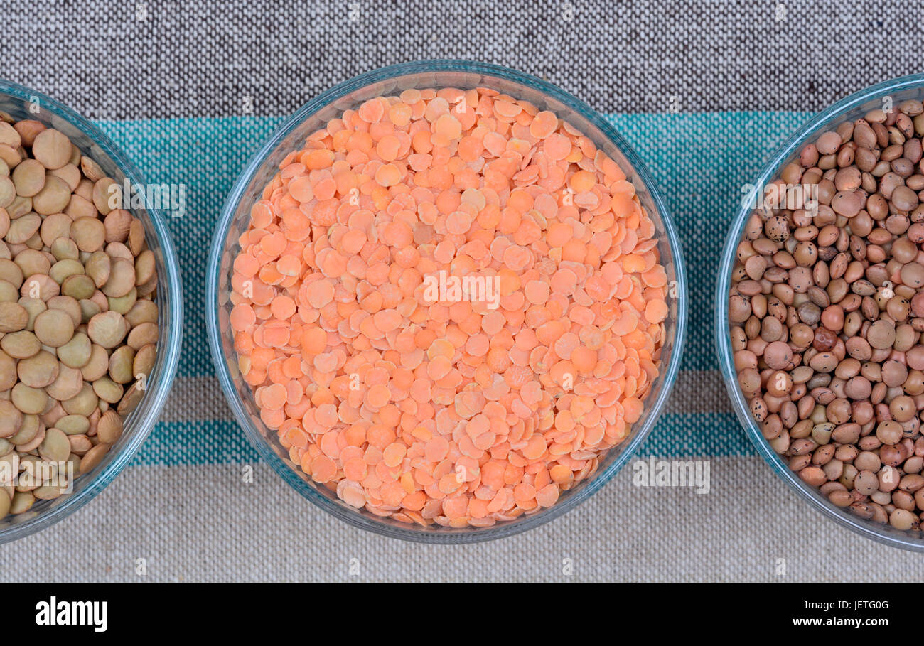 Different types of lentils in a bowls on table close-up Stock Photo - Alamy