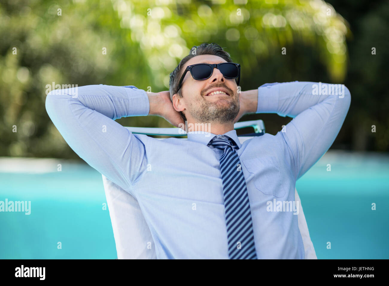 Smart man relaxing on sun lounger Stock Photo - Alamy