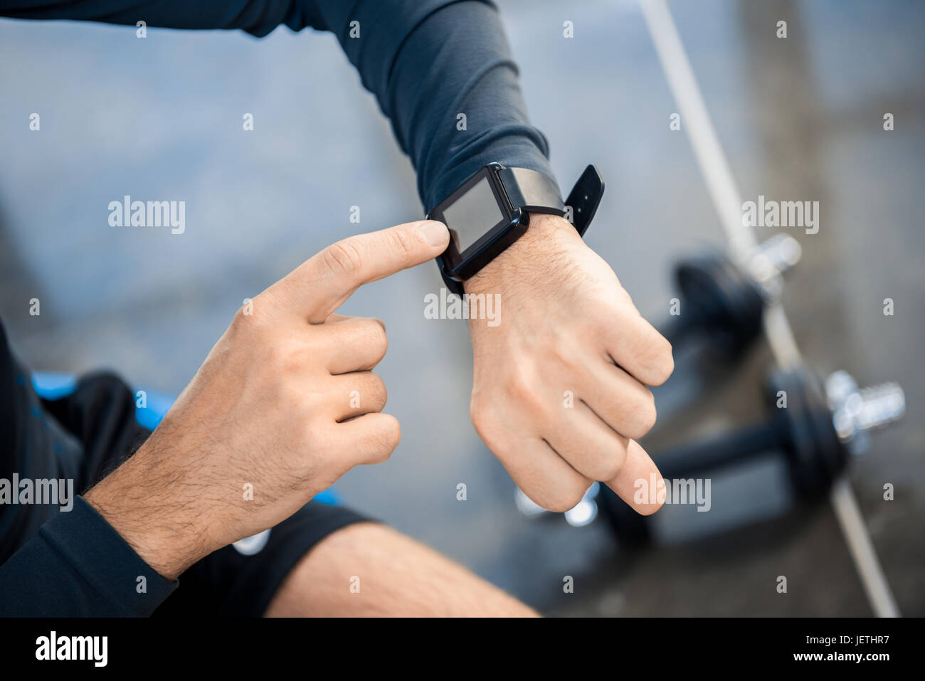 Handsome young man using smartwatch at gym Stock Photo - Alamy