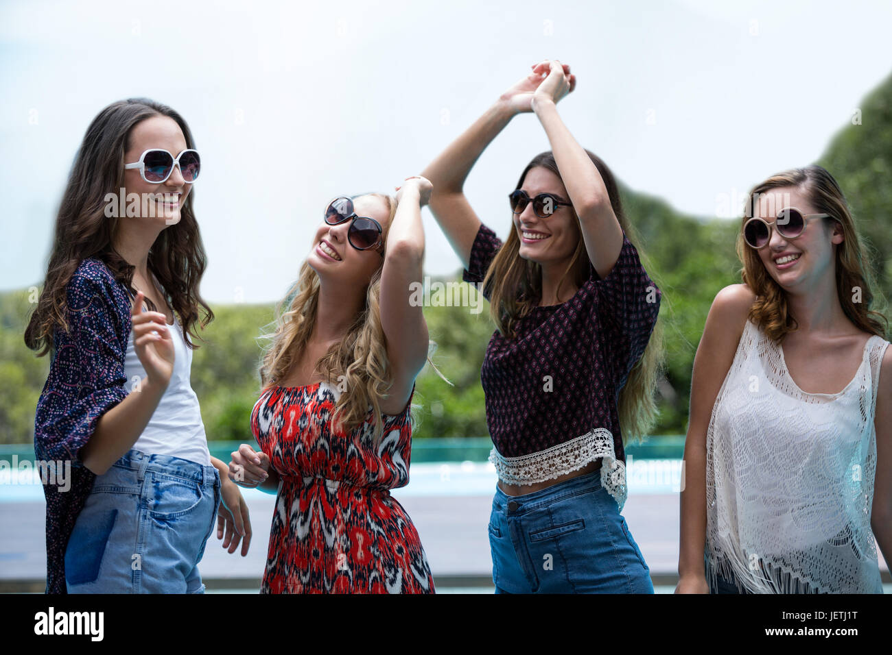 Group of happy women dancing near the pool Stock Photo - Alamy