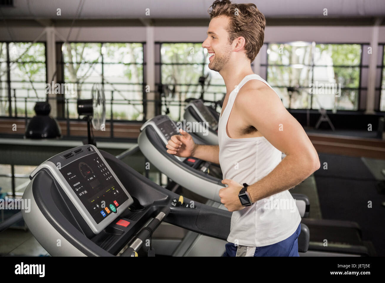 Man running on thread mill Stock Photo - Alamy
