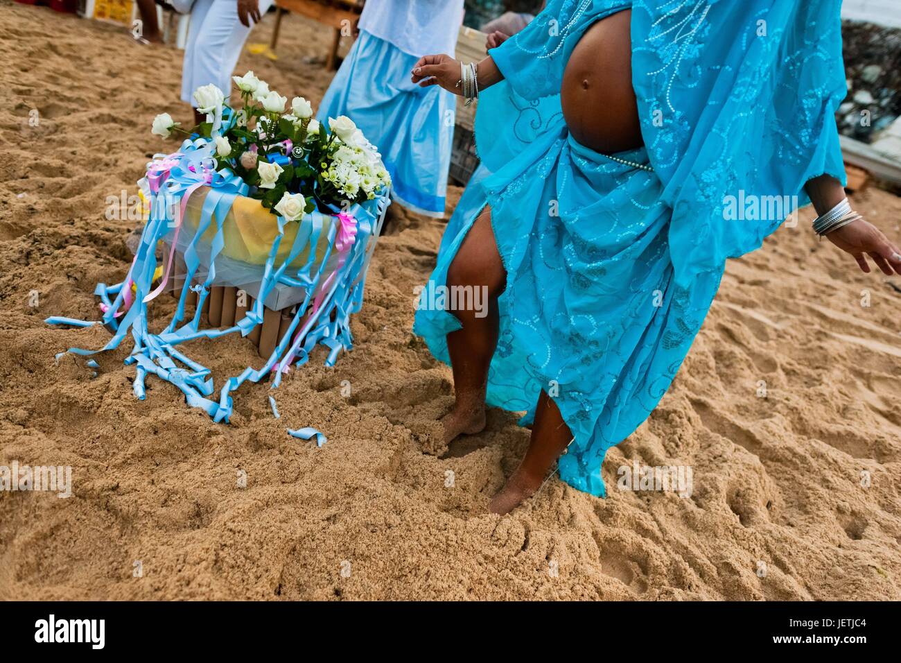 A pregnant Candomble follower dances on the beach during the festival ...