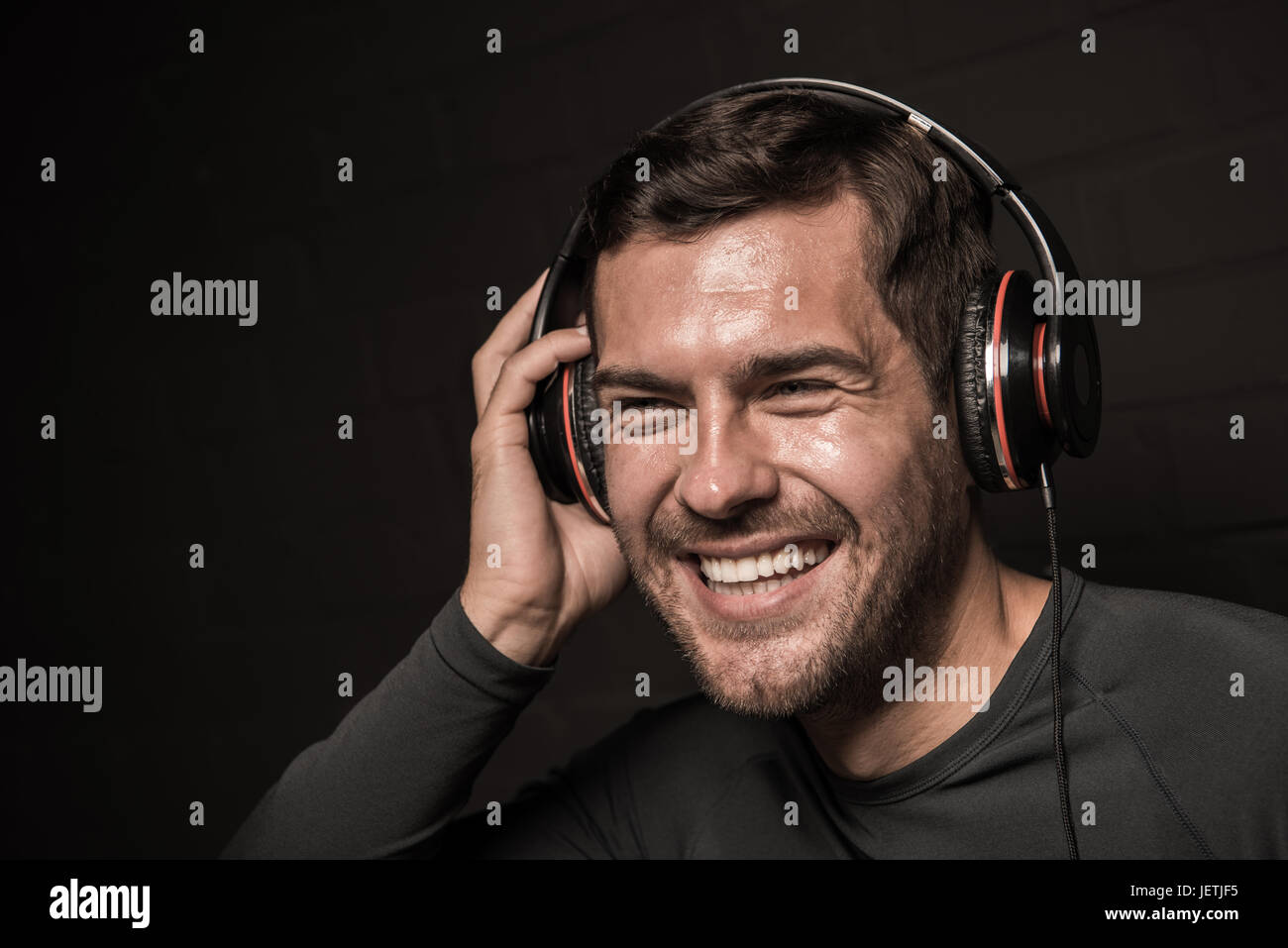 Handsome young man listening hi-res stock photography and images - Alamy