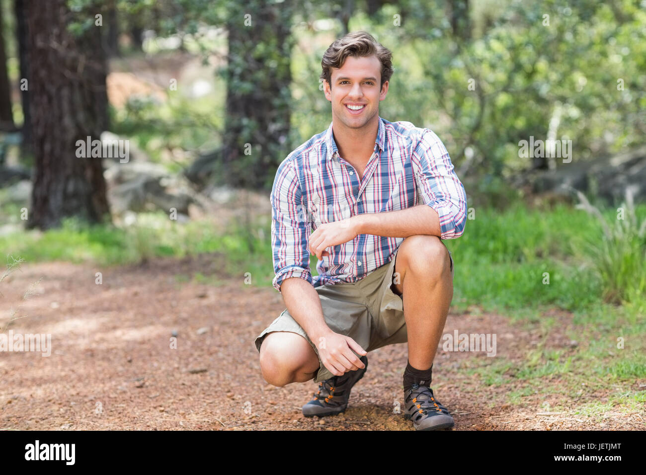 Young man crouching hi-res stock photography and images - Alamy