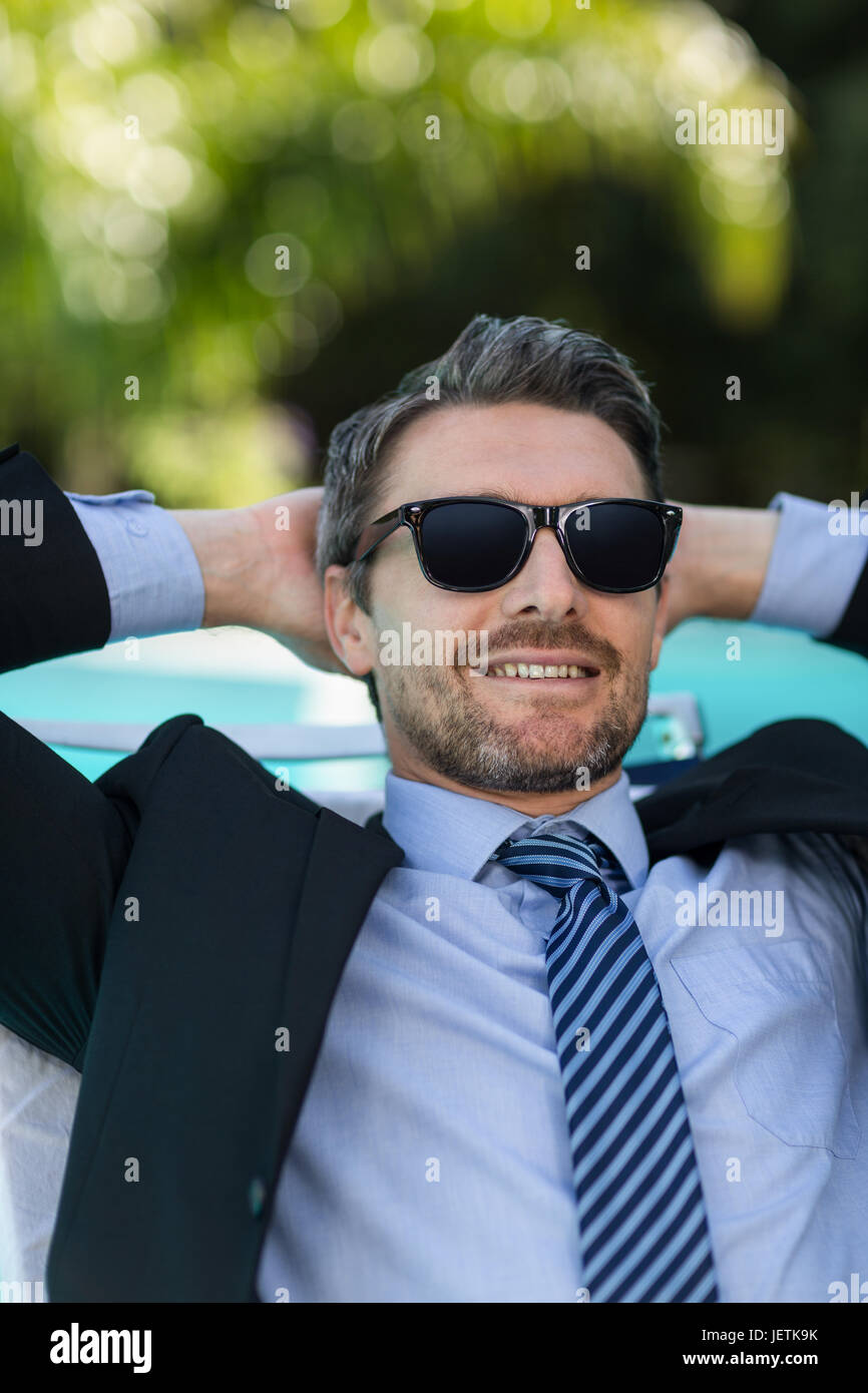 Smart man relaxing on sun lounger Stock Photo - Alamy