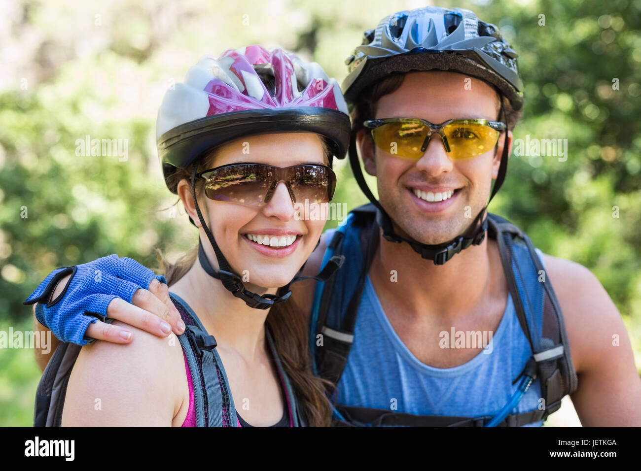 Portrait of happy couple wearing helmets Stock Photo - Alamy
