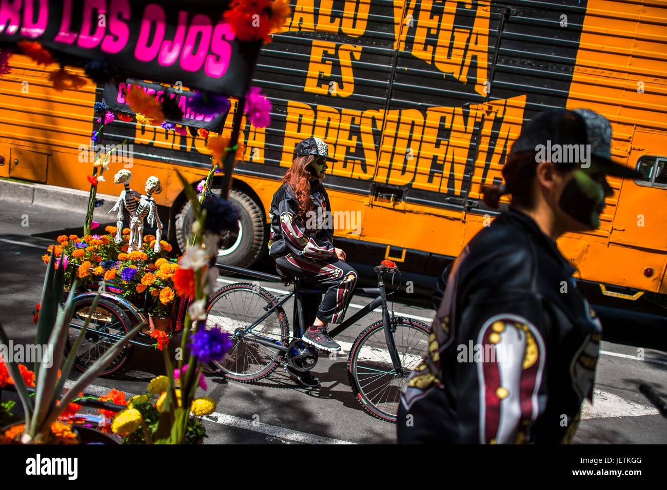A Mexican girl, dressed as skeleton (Calaca), performs on a bicycle ...