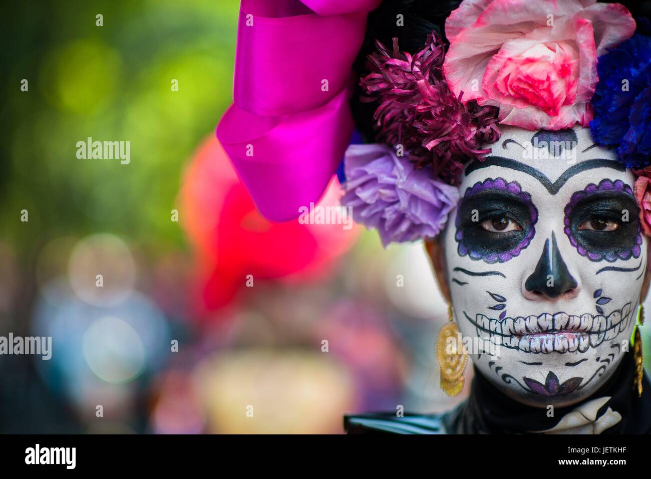 A young woman, dressed as La Catrina, a Mexican pop culture icon ...