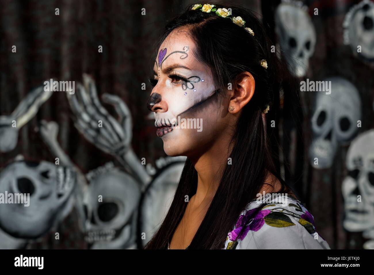A young woman, dressed as La Catrina, a Mexican pop culture icon ...