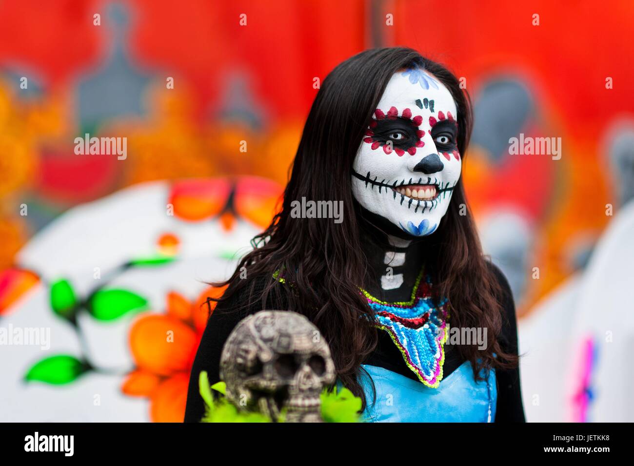A young woman, dressed as La Catrina, a Mexican pop culture icon ...