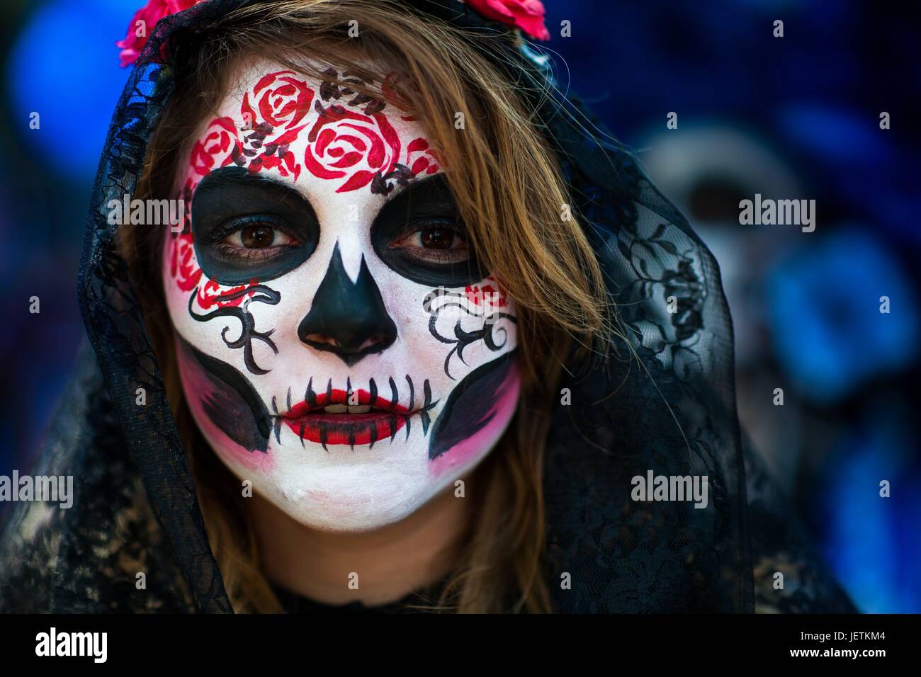 A young woman, dressed as La Catrina, a Mexican pop culture icon ...