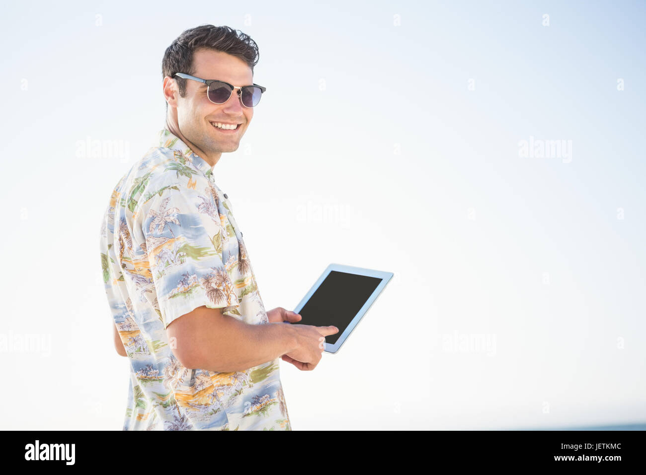Smiling man using tablet Stock Photo - Alamy