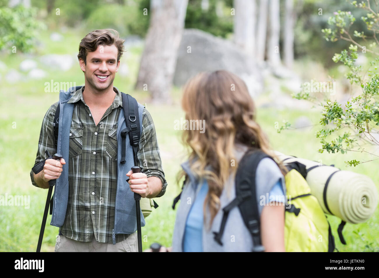 Happy hiker looking at young woman Stock Photo - Alamy