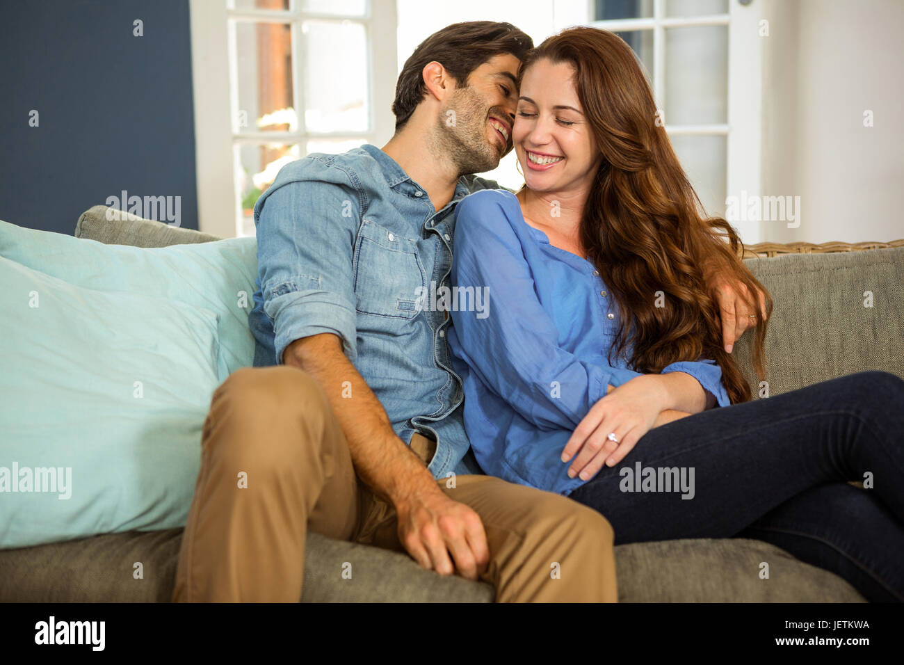 Happy young couple embracing each other Stock Photo - Alamy