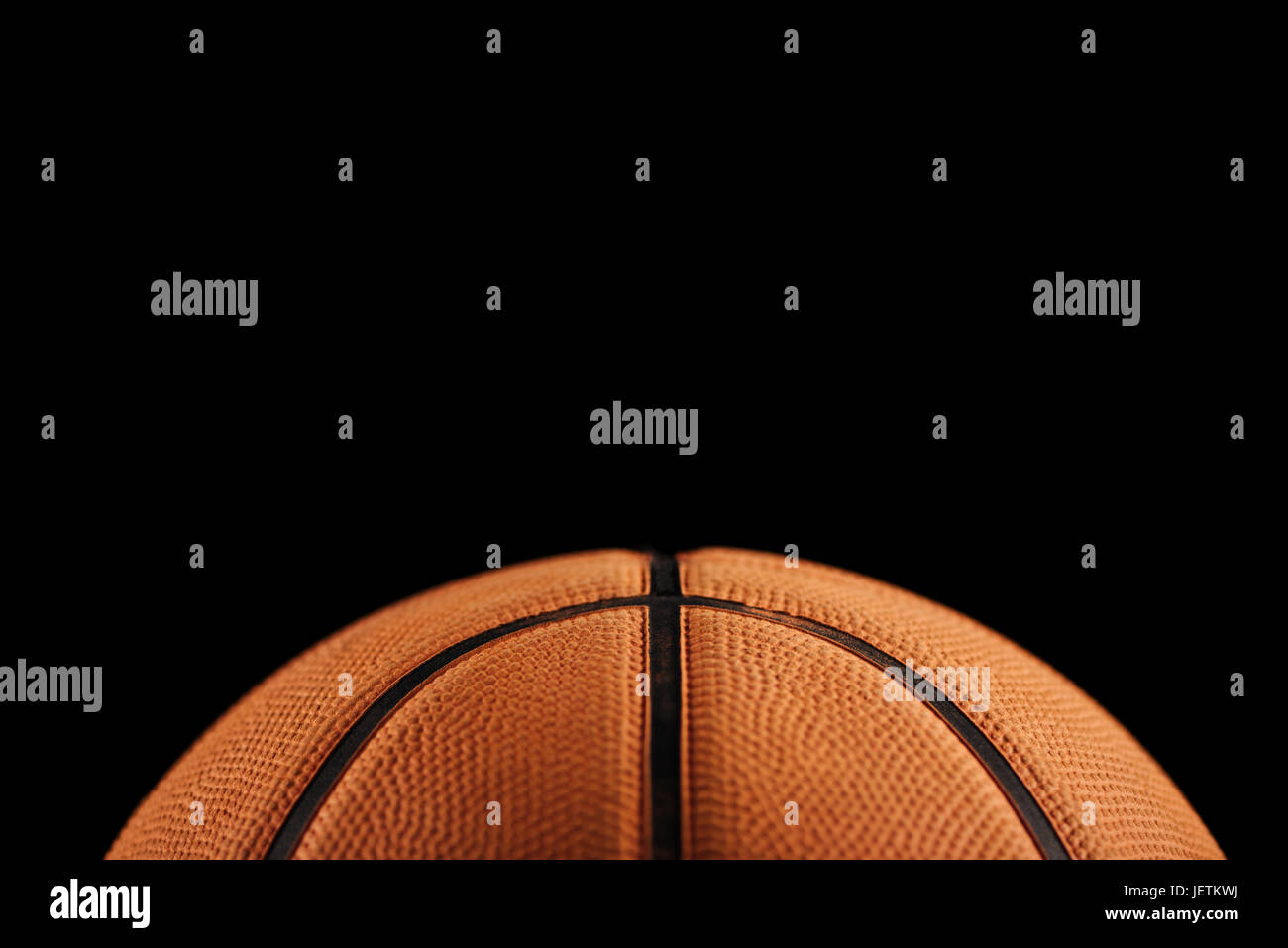 Close-up view of traditional basketball ball isolated on black ...