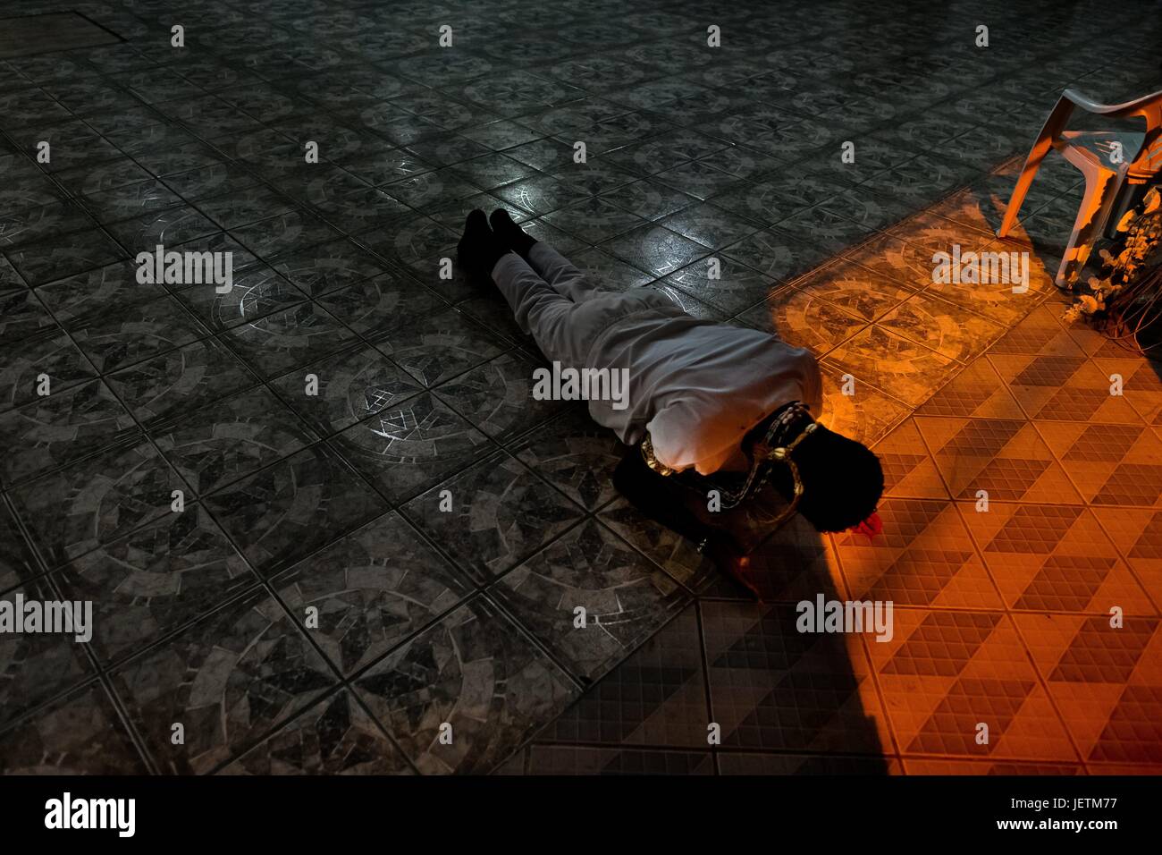 A Candomble follower prays during an Afro-Brazilian religious ritual in ...