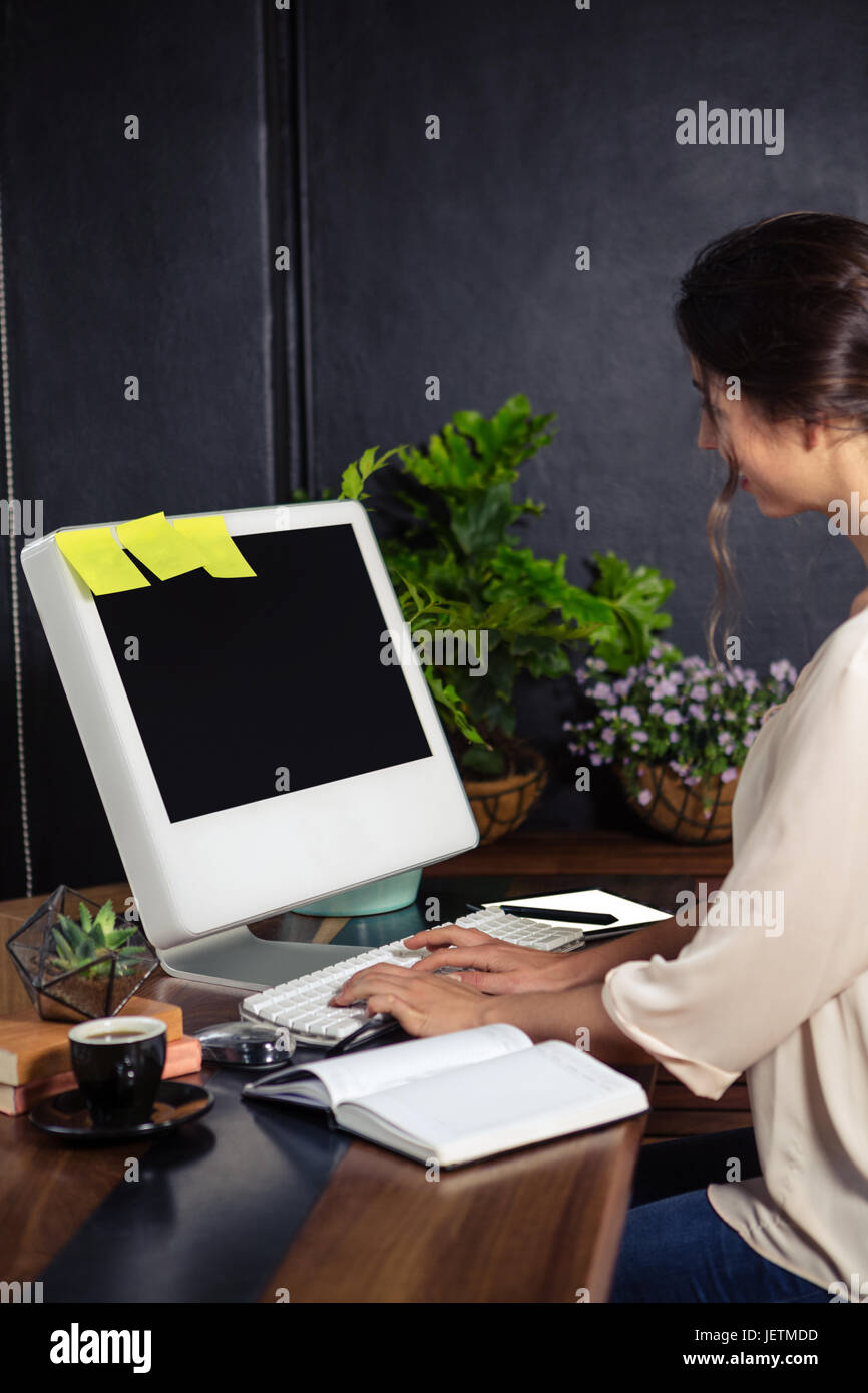Businesswoman using her computer Stock Photo - Alamy