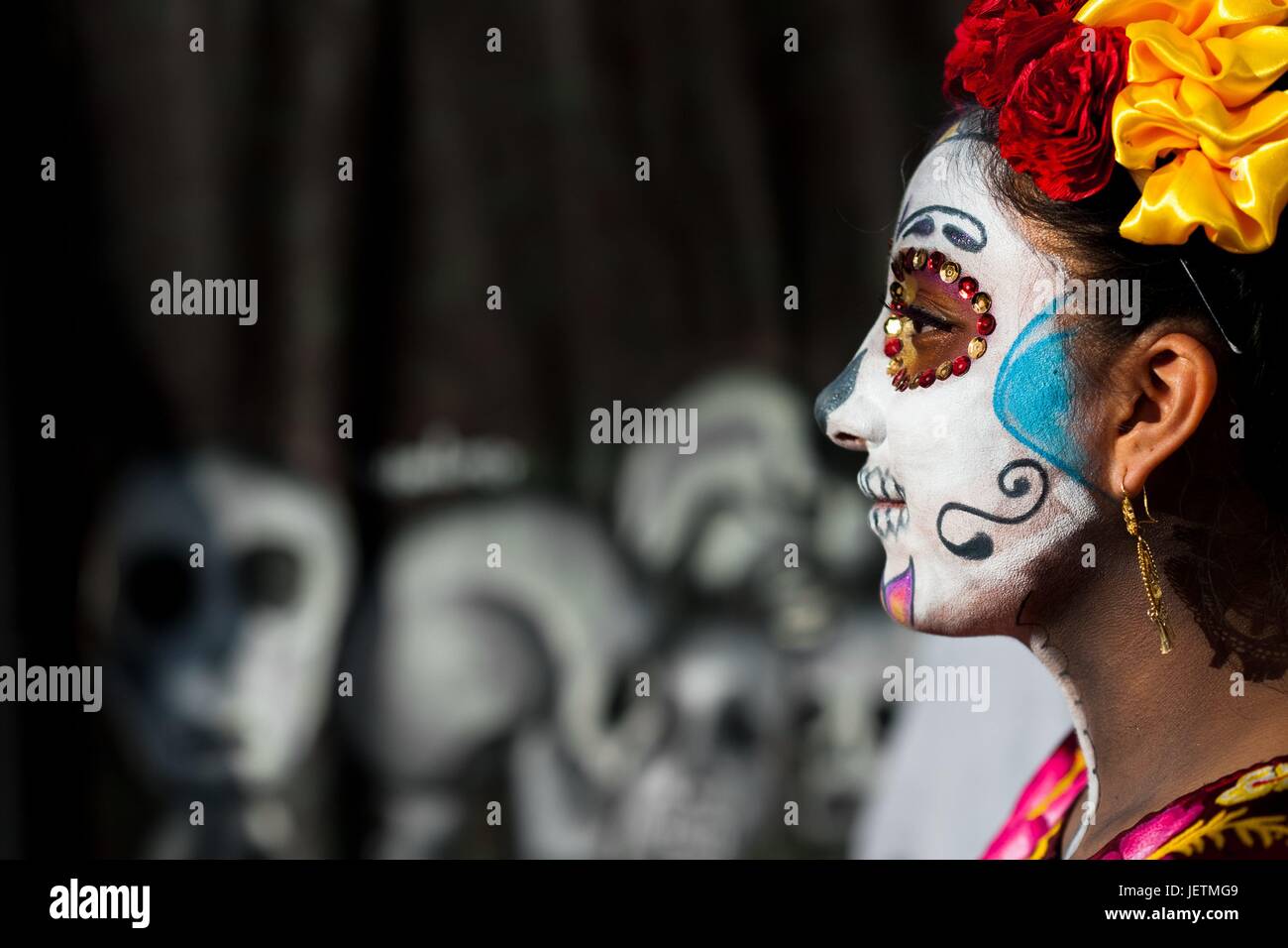 A young woman, dressed as La Catrina, a Mexican pop culture icon ...