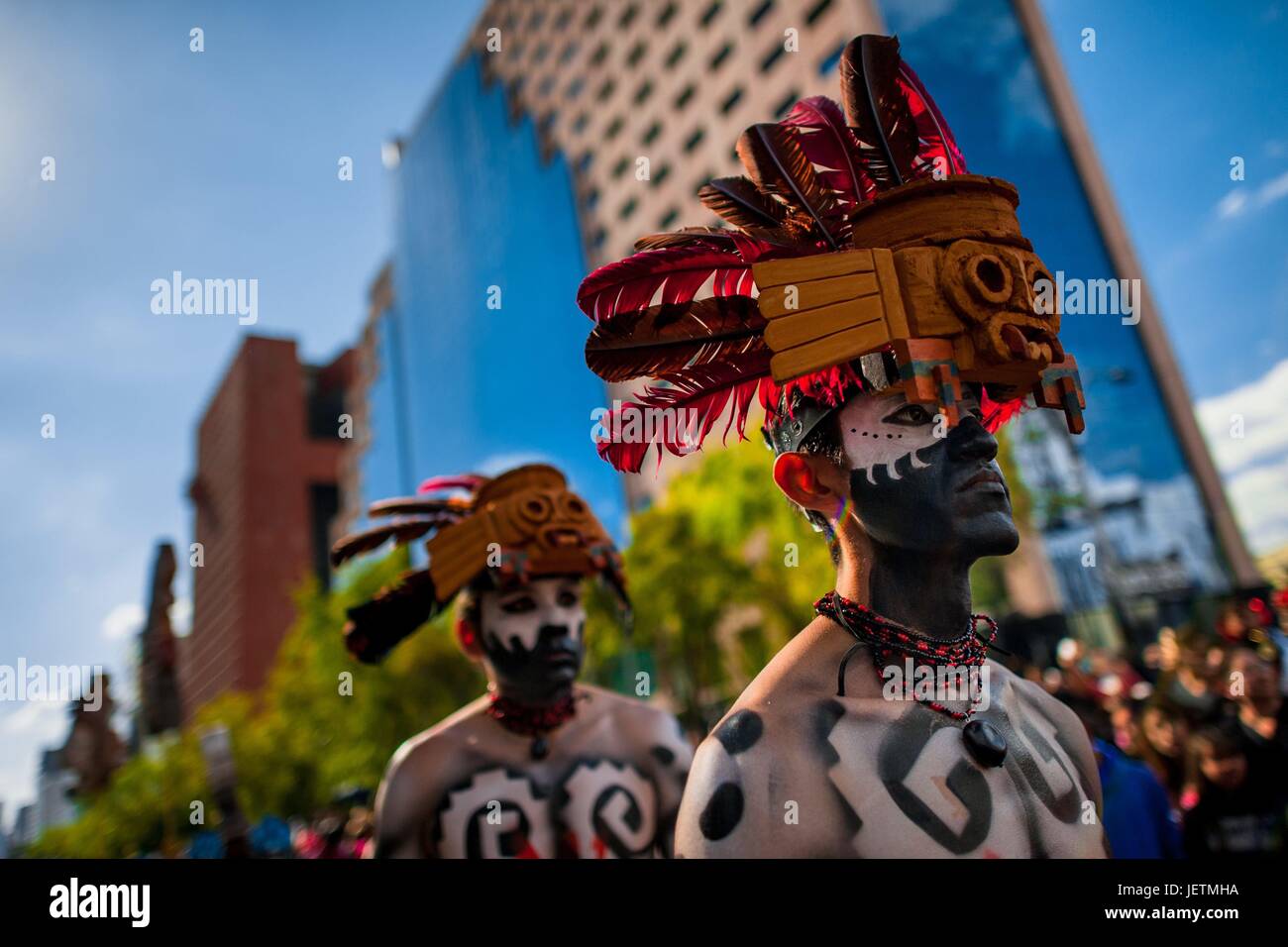 Mexican men, wearing colorful feather masks inspired by Aztecs, take ...