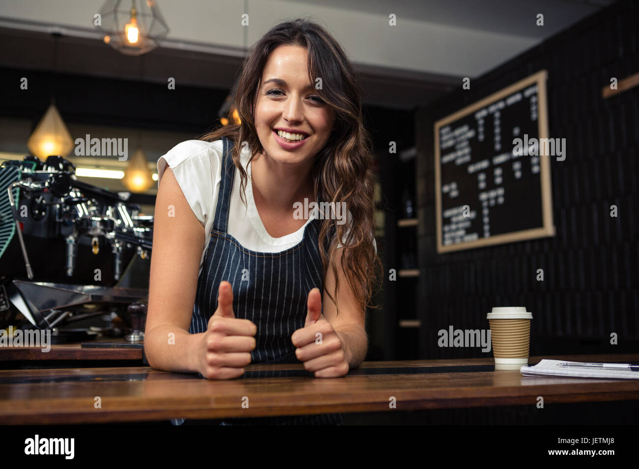 Portrait of smiling barista with thumbs up Stock Photo - Alamy