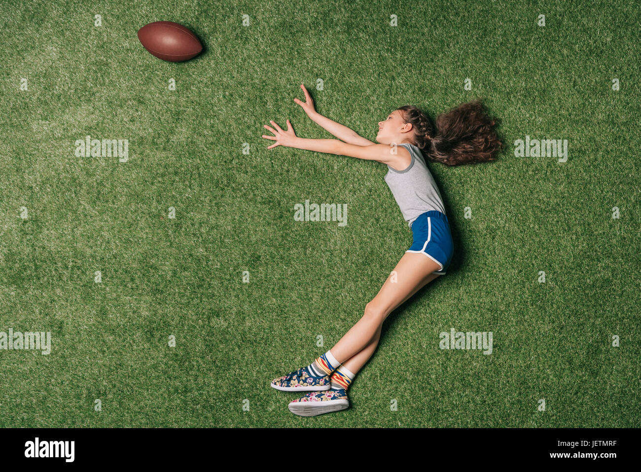 Girl catching rugby ball hi-res stock photography and images - Alamy