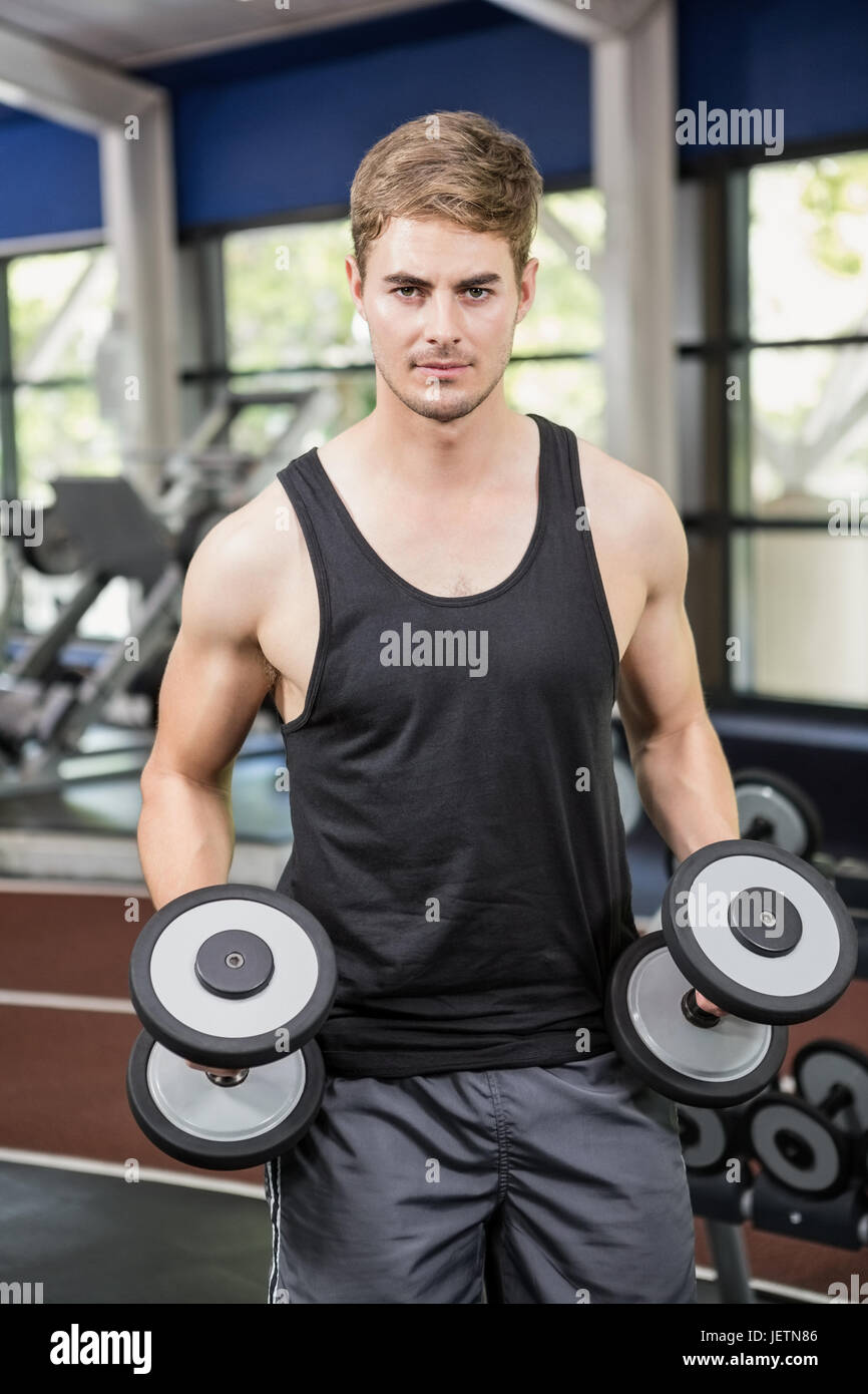 Man lifting a heavy dumbbells Stock Photo - Alamy