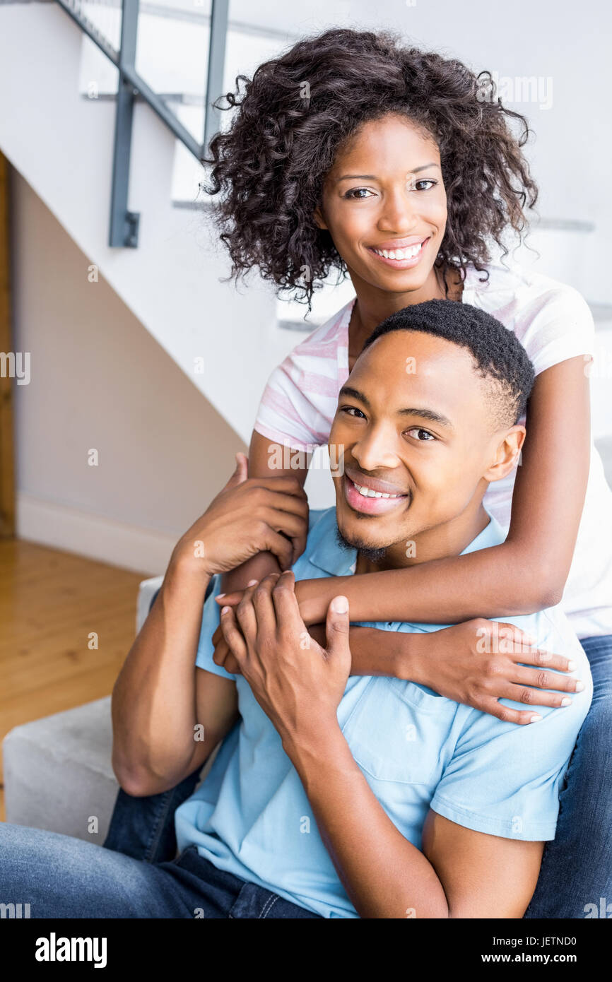 Young couple embracing on steps Stock Photo - Alamy