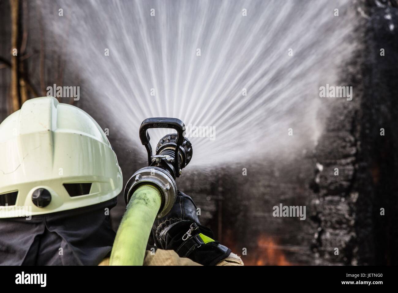 Firefighters use a diffuser spray nozzle to put a fire, Fellbach ...