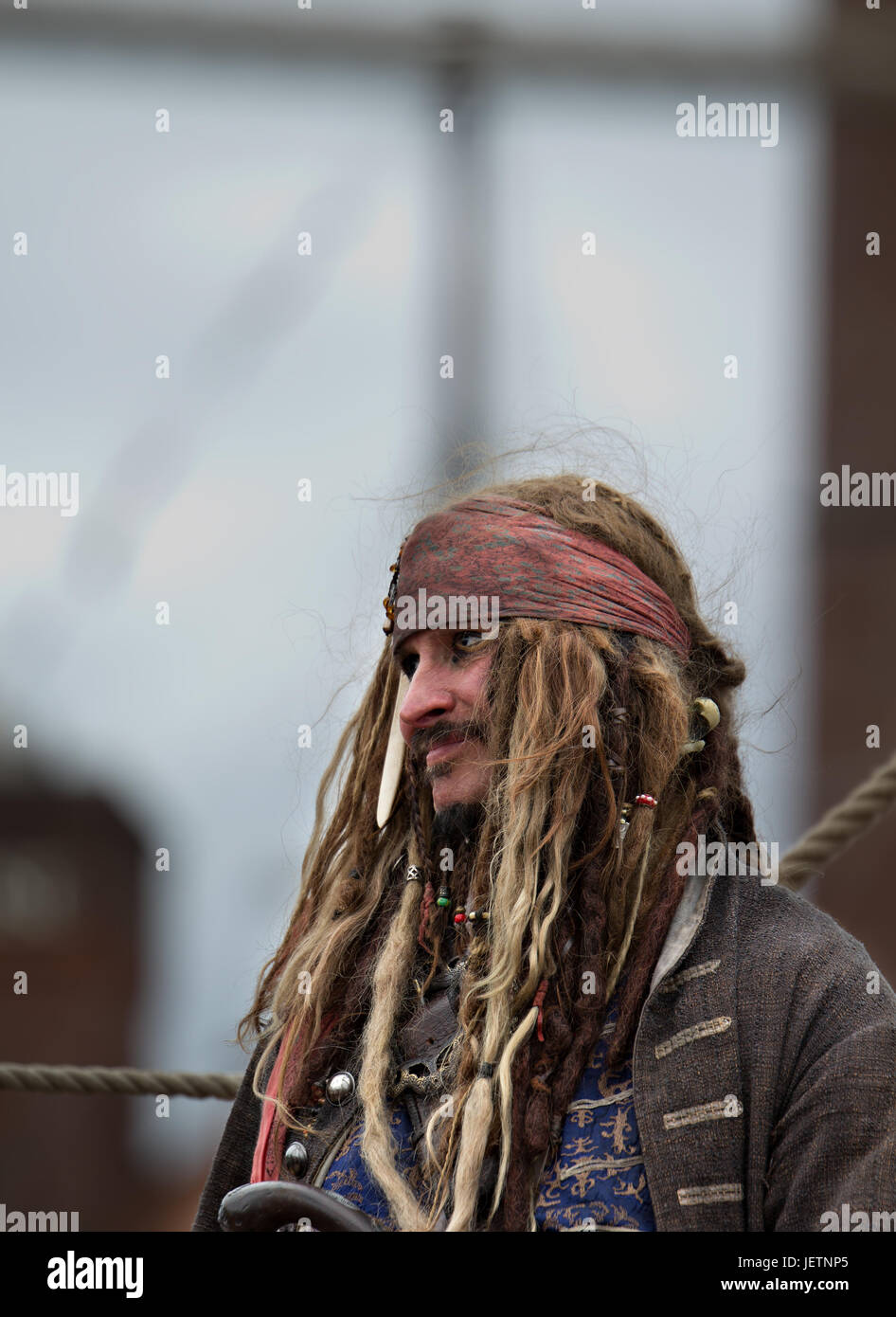 A man dressed as a pirate to welcome people aboard a tall ship at the ...