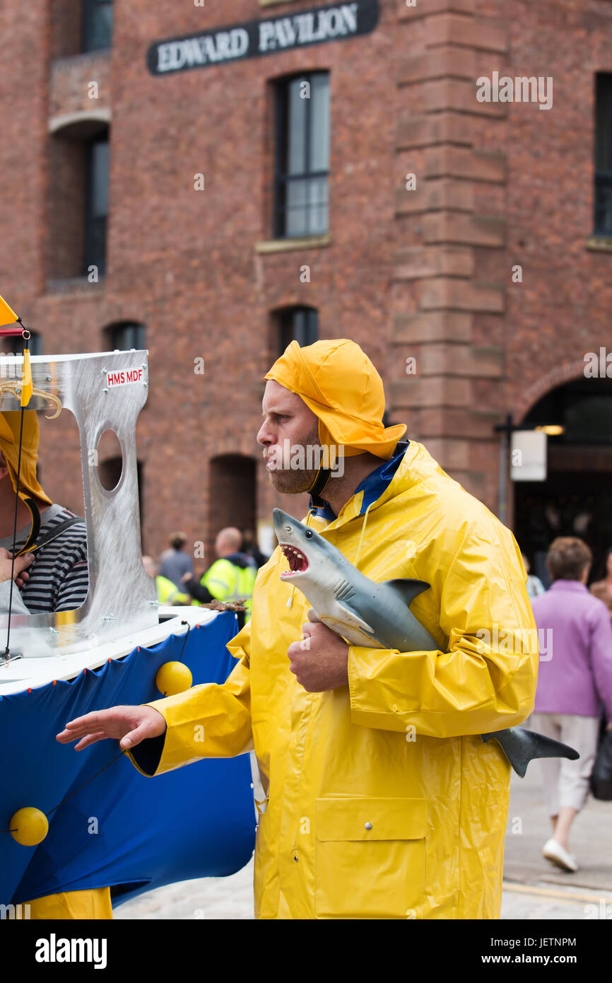 Men dressed as trawlermen in a toy boat and carrying a plastic shark to ...