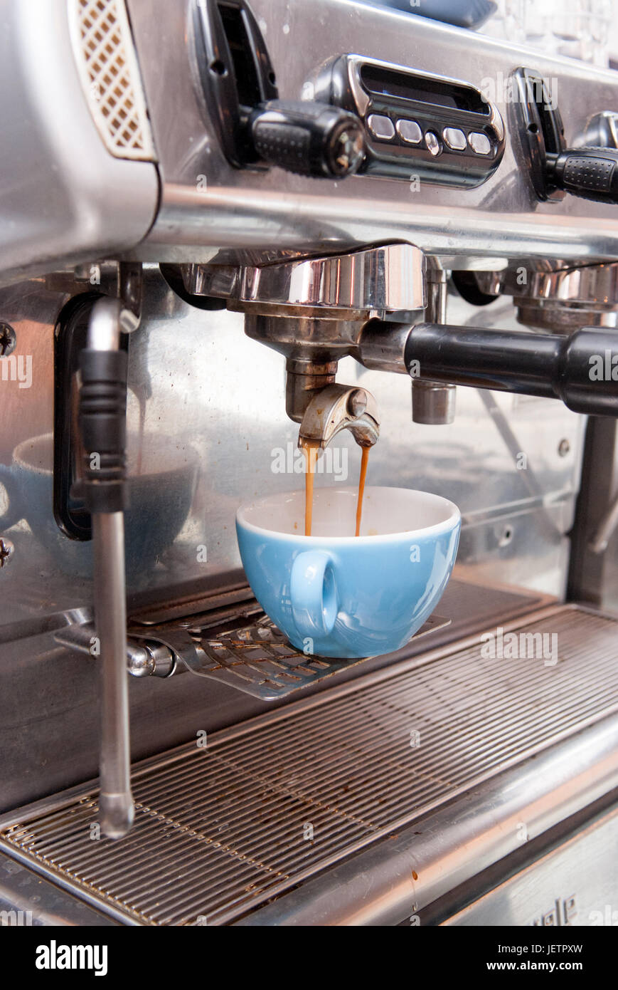 Pouring fresh coffee from the machine in the coffee shop Stock Photo ...