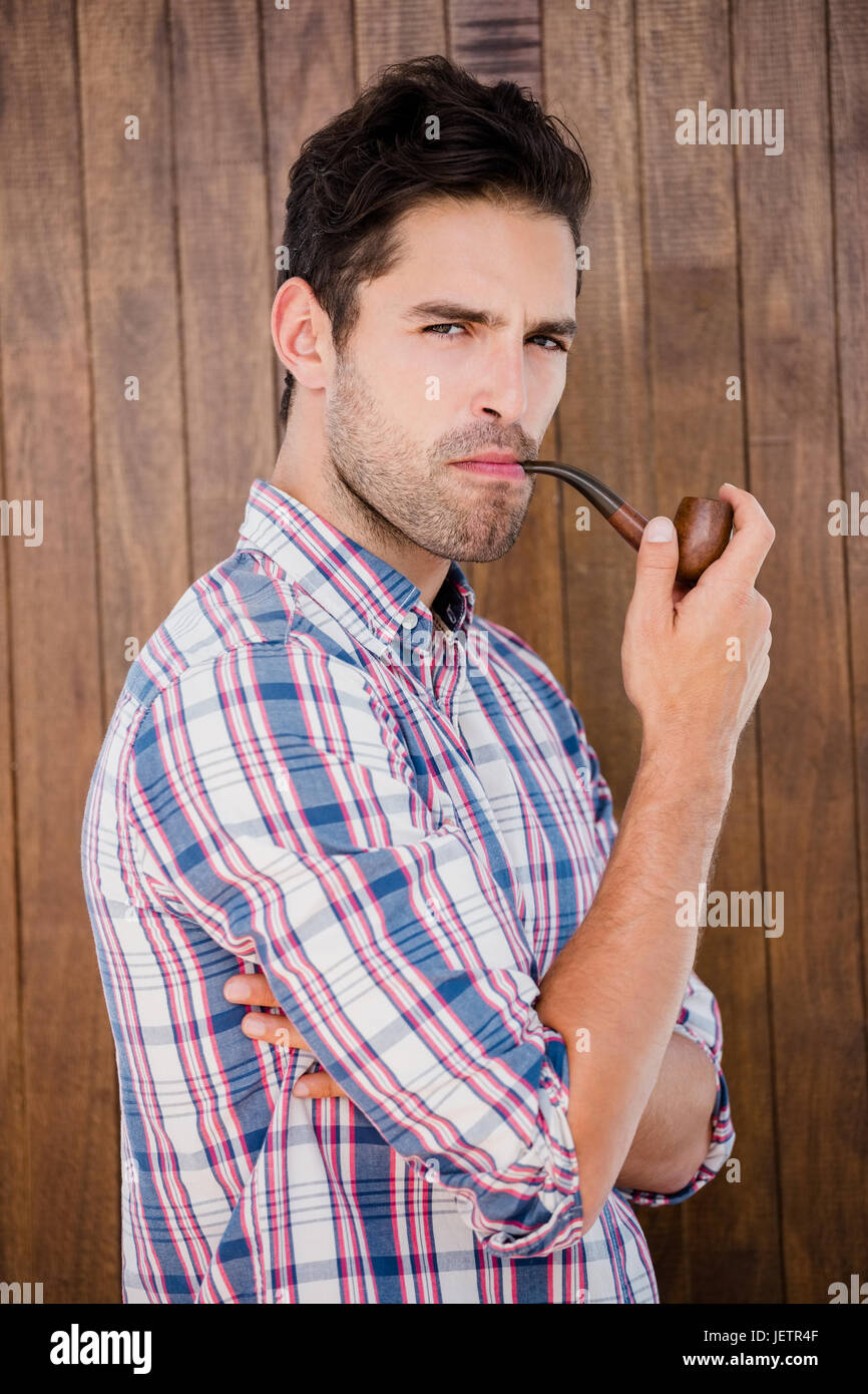 Young man smoking pipe Stock Photo - Alamy