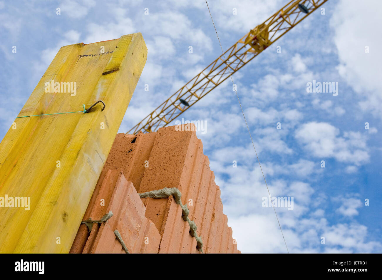 Shell-brick wall from the worm's-eye view with construction crane ...