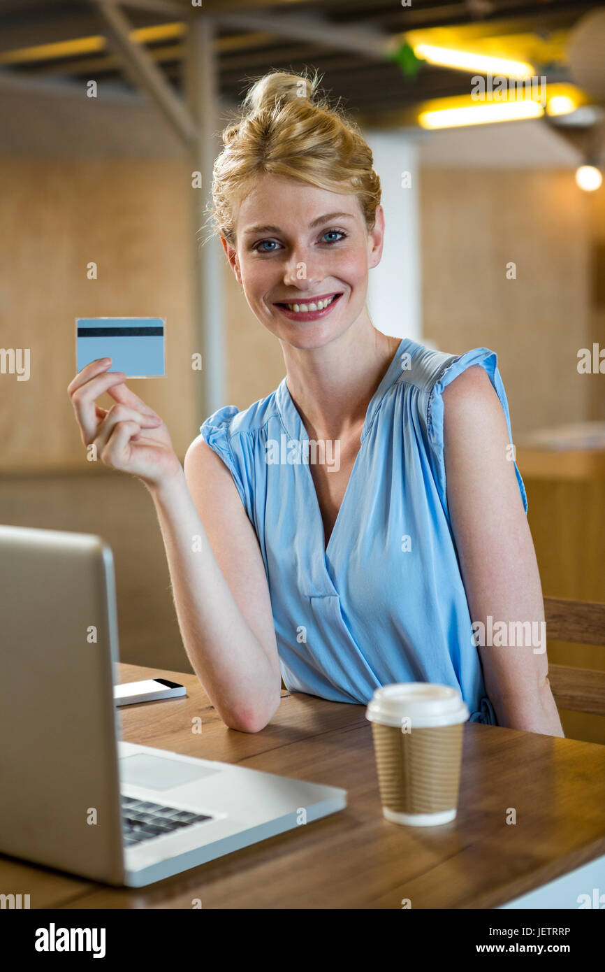 Beautiful woman showing credit card Stock Photo - Alamy