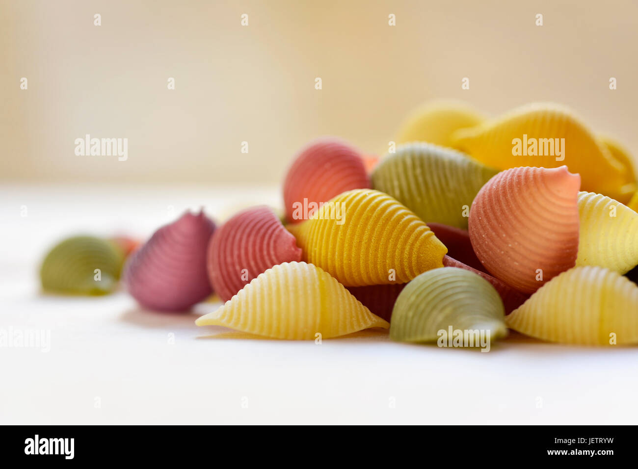 closeup of a pile of uncooked conchiglie, italian seashell pasta, with ...