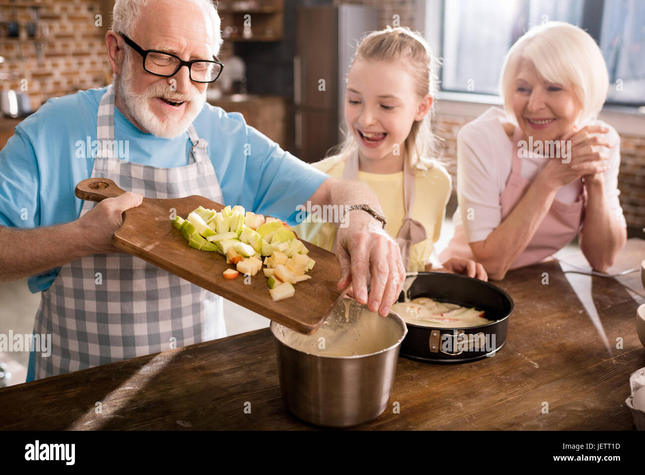 smiling grandparents and girl cooking together at home Stock Photo - Alamy