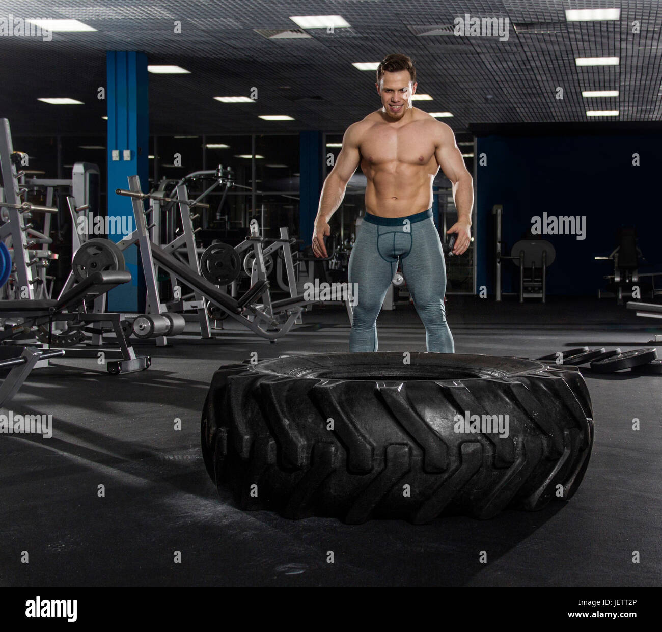 Muscular,Strong and fit man preparing to push tire in modern fitness ...