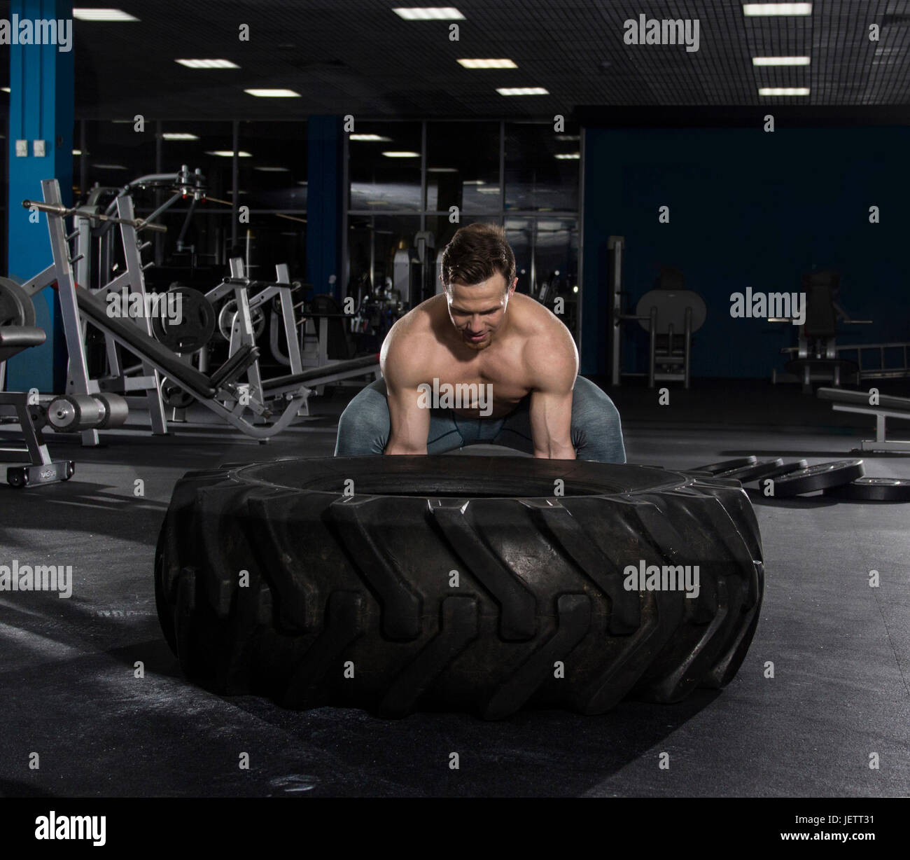 Muscular,Strong and fit man preparing to push tire in modern fitness ...