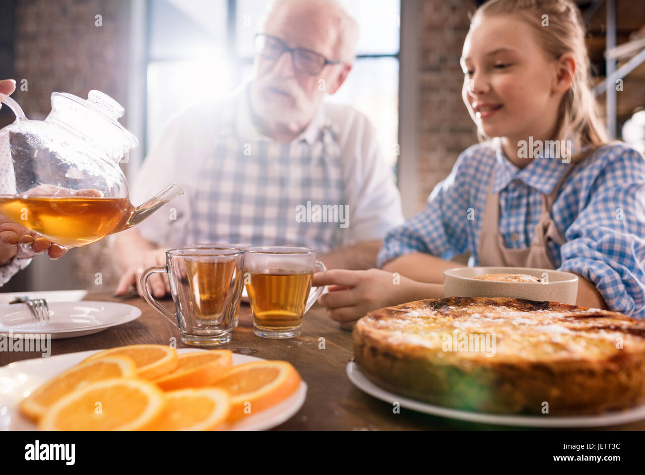 grandparents and girl drinking tea with pie together at home Stock ...