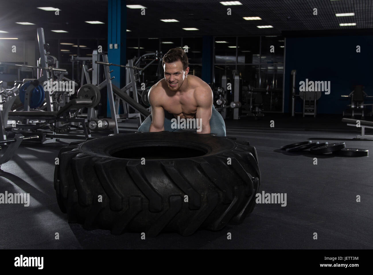 Muscular,Strong and fit man preparing to push tire in modern fitness ...