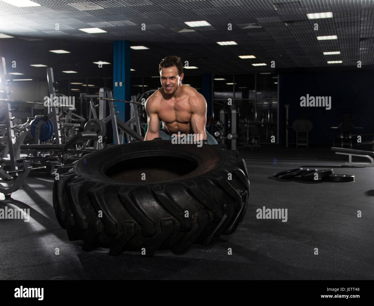 Muscular,Strong and fit man preparing to push tire in modern fitness ...