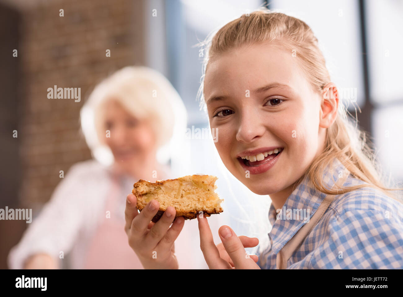 portrait of smiling girl eating homemade pie Stock Photo - Alamy