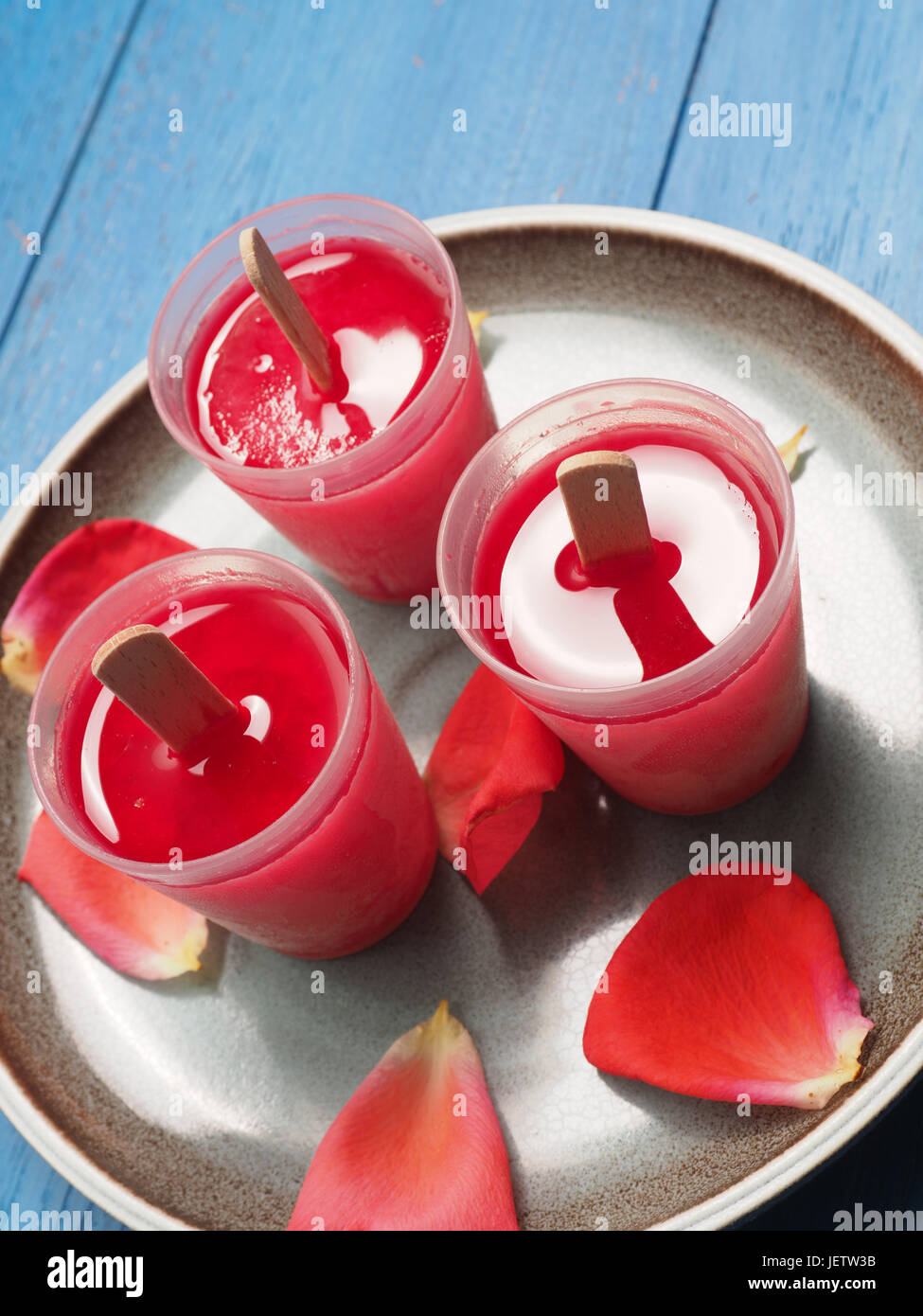 Fruity red water ice on a blue plate Stock Photo - Alamy