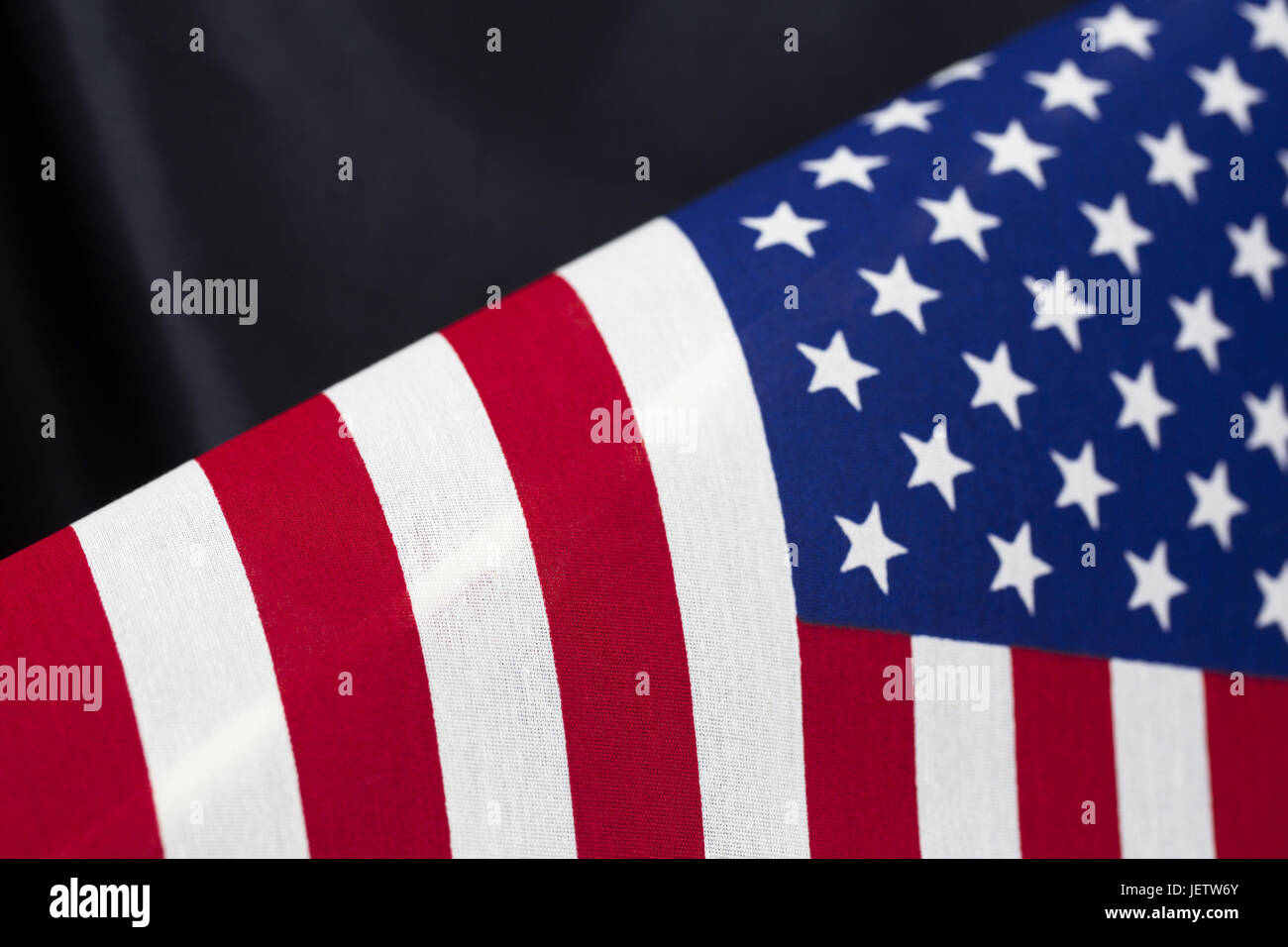 Stars and stripes American flag pattern against simple, black satin ...