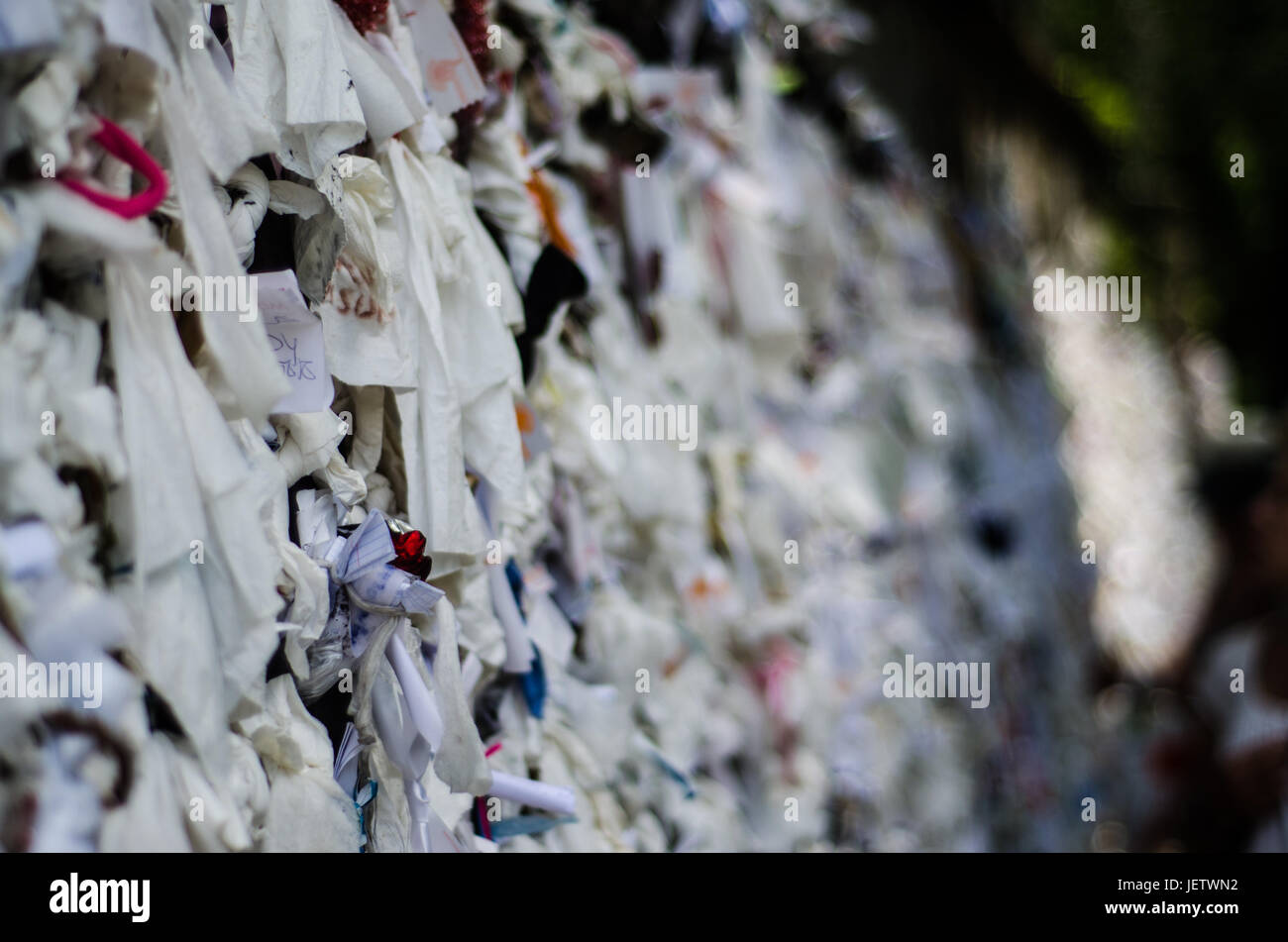 Prayers or wish ribbons on a wall written on tissues at the Virgin Mary ...