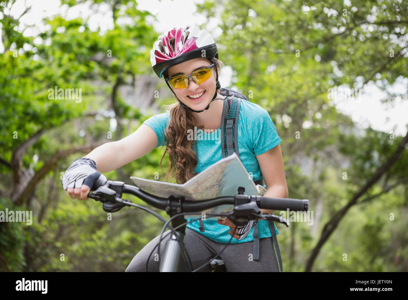 Smiling woman checking the map Stock Photo - Alamy