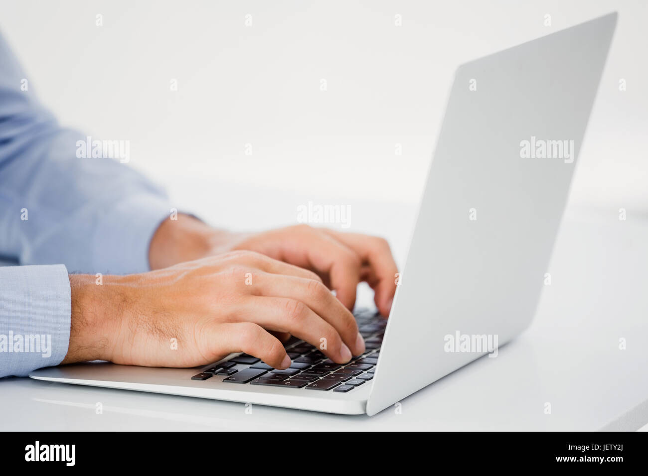 Mid-section of businessman working on laptop Stock Photo - Alamy